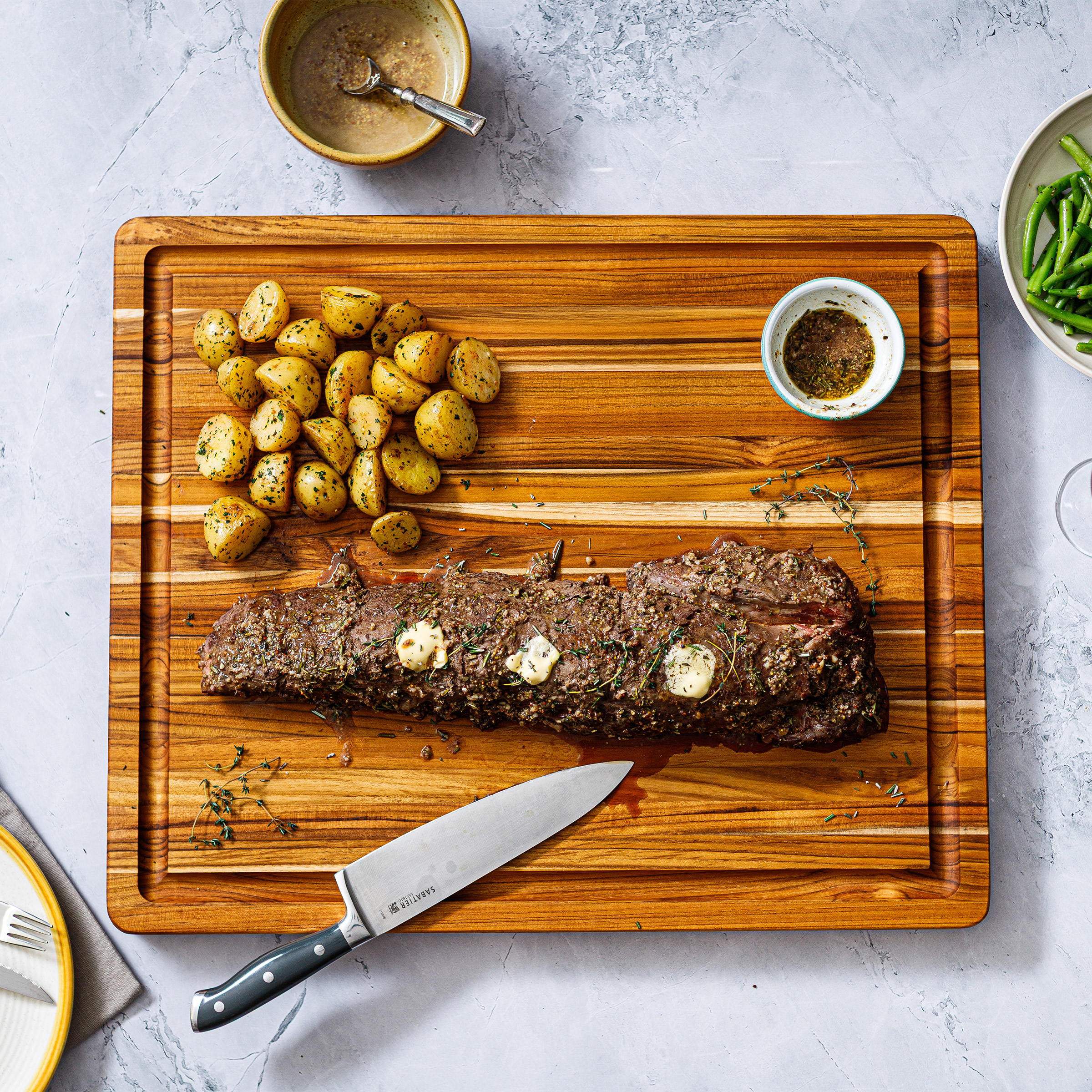 Teakhaus 58.42 cm (23 in.) Reversible Cutting Board | Costco